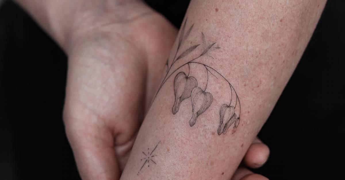 Bleeding heart flower tattoo located on the forearm.