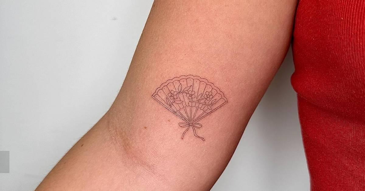 Single needle hand fan tattoo located on the inner arm.