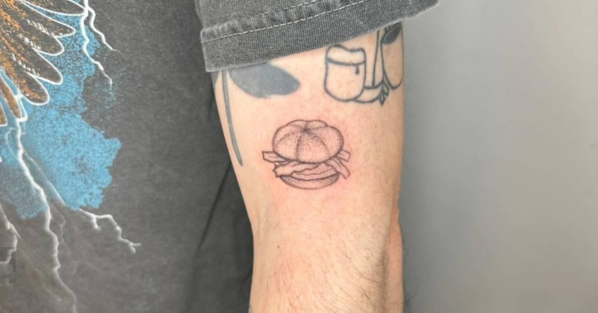Bacon sandwich tattoo located on the upper arm.