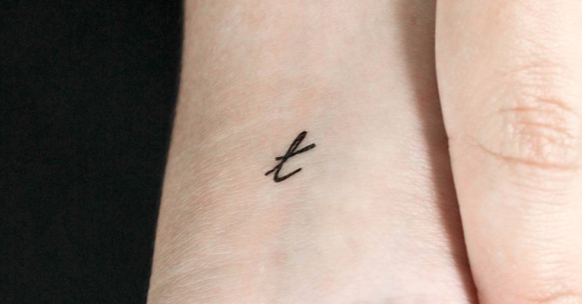 "T" handwritten letter temporary tattoo located on the
