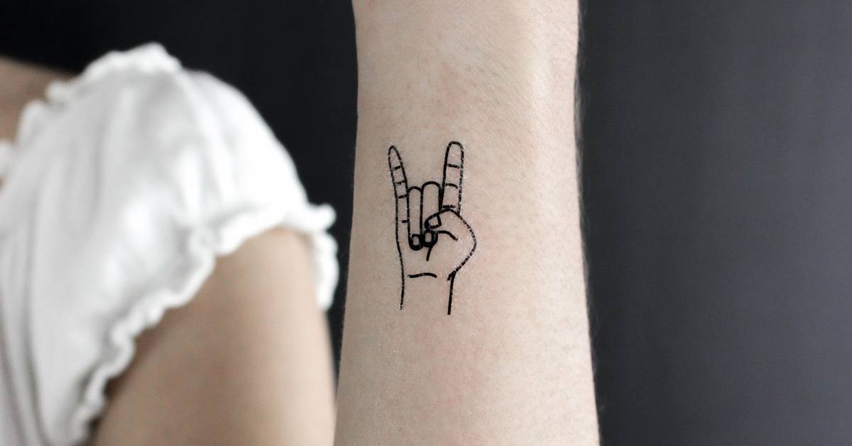 Minimalistic style rock salute temporary tattoo located