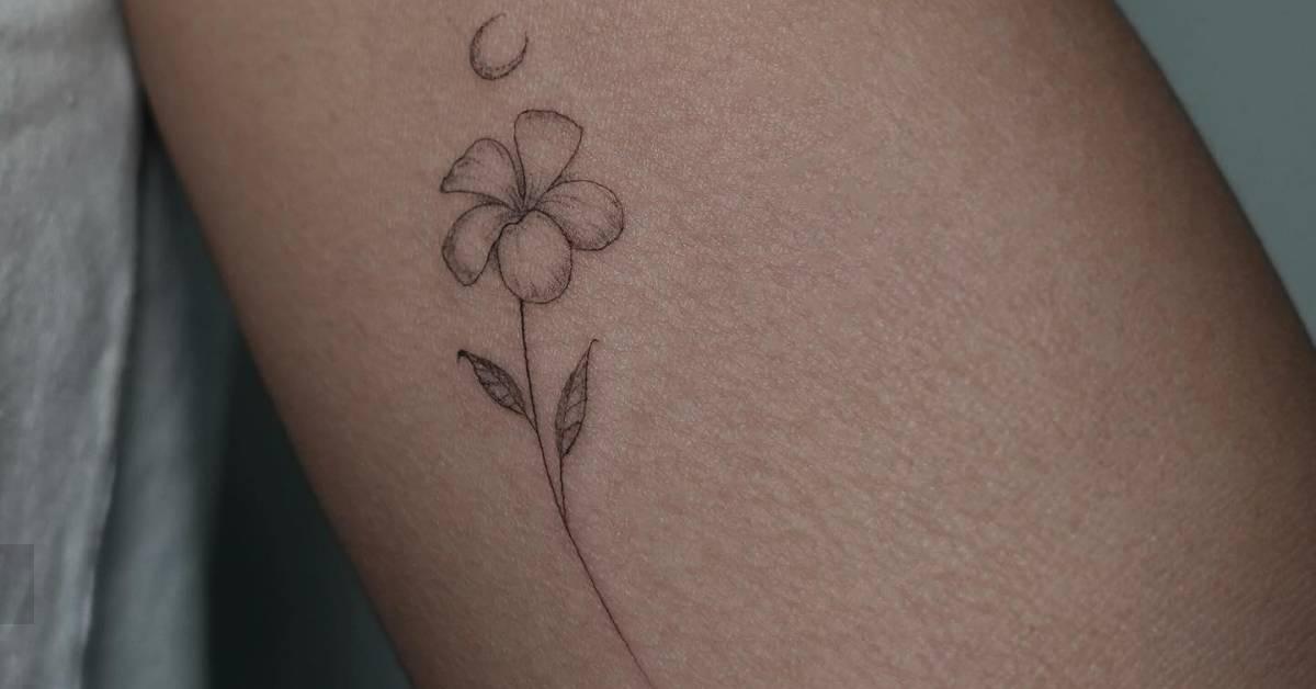 Single needle flower tattoo located on the inner arm.