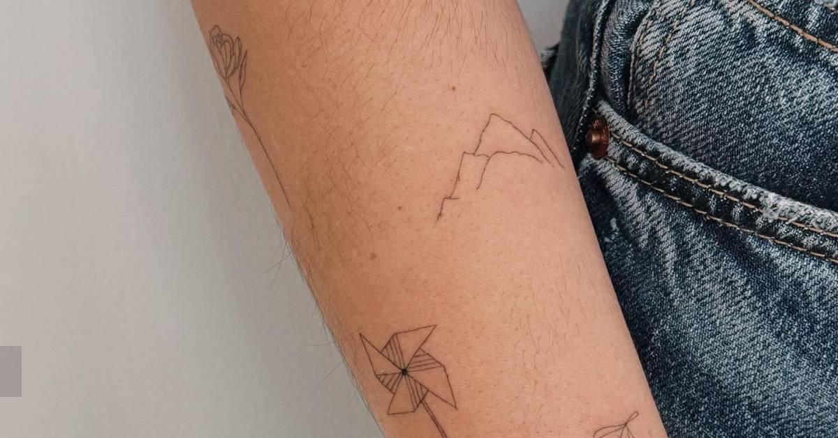 Fine line style forearm composition tattoos.