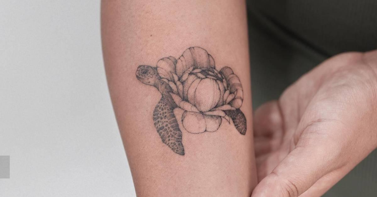 Peony turtle tattoo located on the inner forearm.