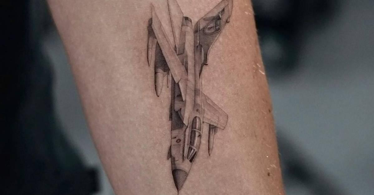Micro-realistic style jet fighter tattoo located on the