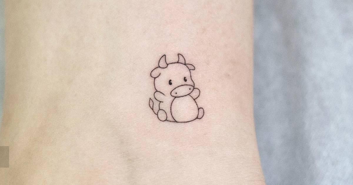 Minimalistic style cow tattoo located on the ankle.