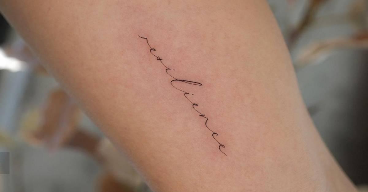 Tattoo of the word "resilience" handwritten on the