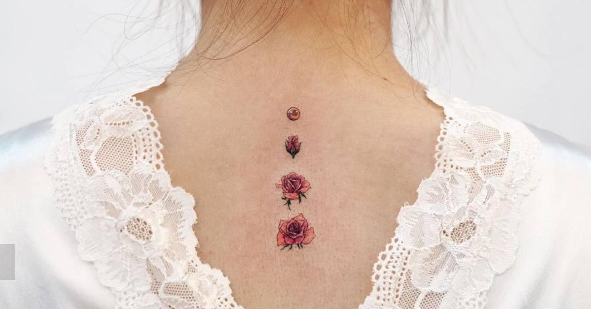 Blooming red rose tattoo placed on the upper back.