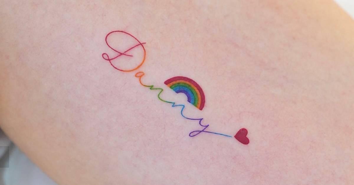 Name "Danny" and rainbow tattoo located on the inner