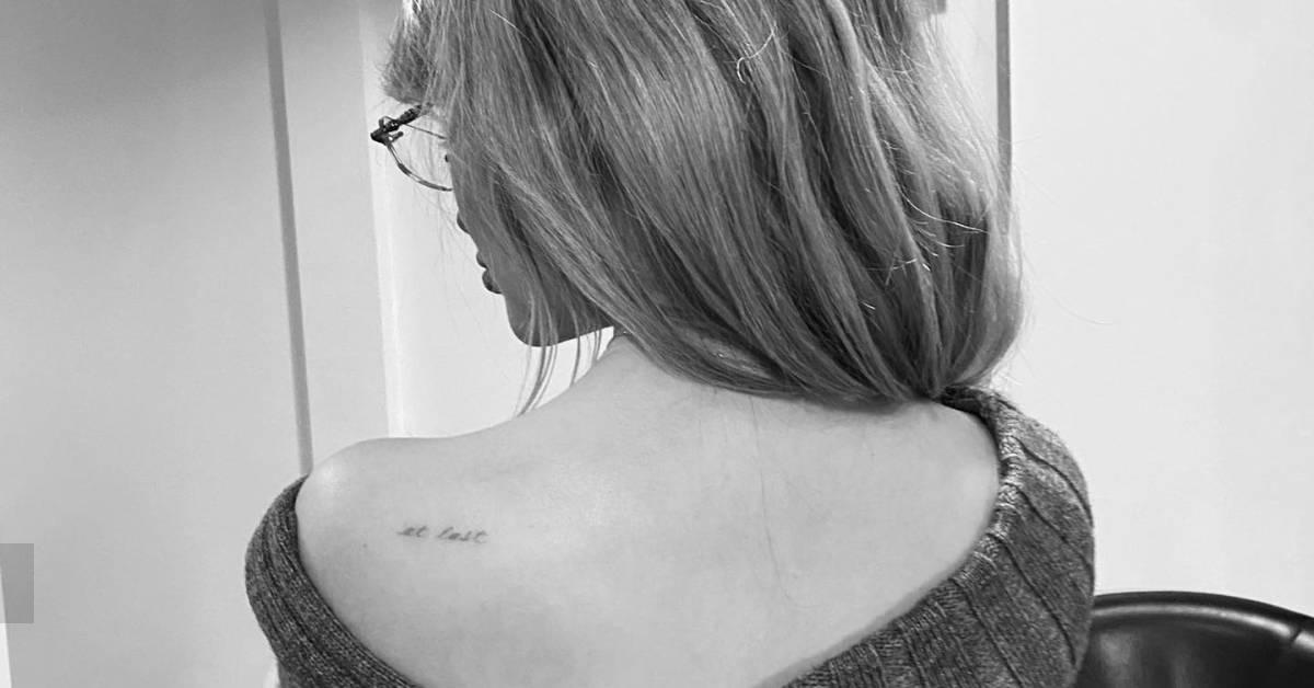 "At last" lettering tattoo located on Sabrina