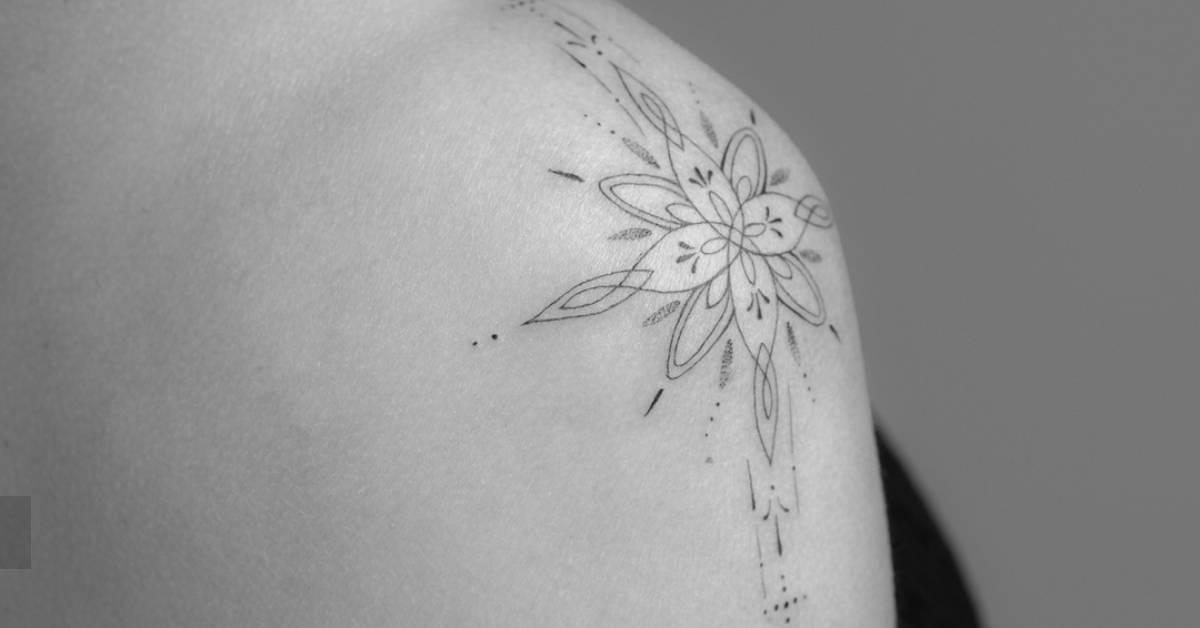 Fine line style ornamental tattoo placed on the