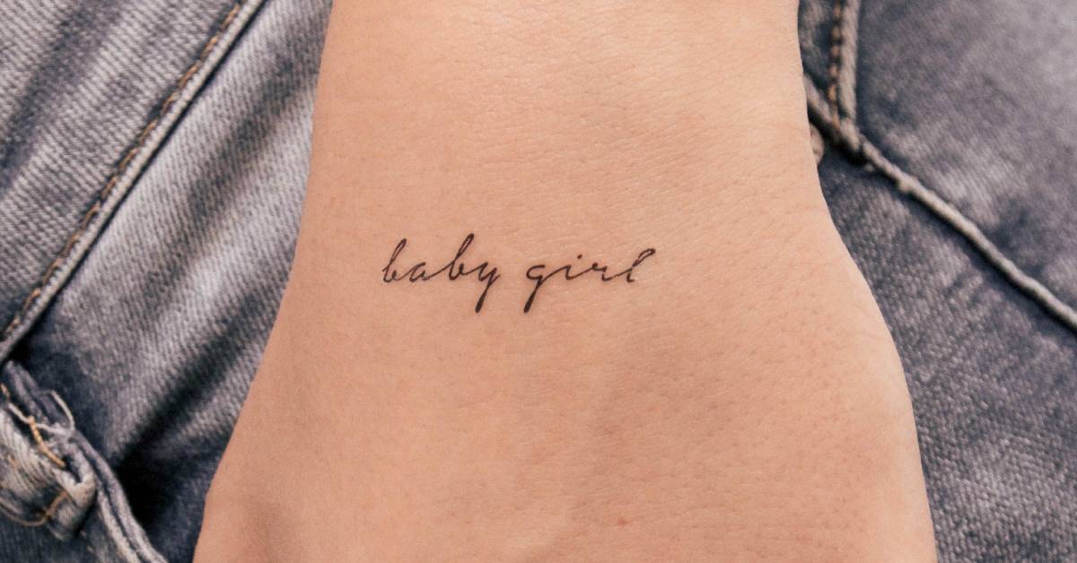 "Baby girl" temporary lettering tattoo placed on the