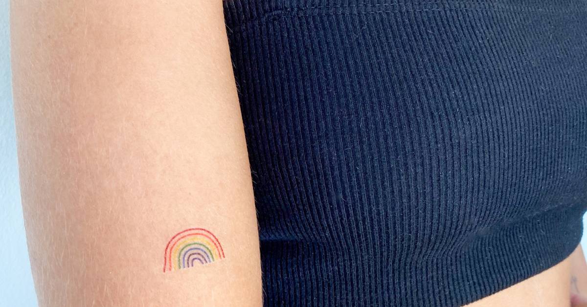 Minimalist color rainbow temporary tattoo located on