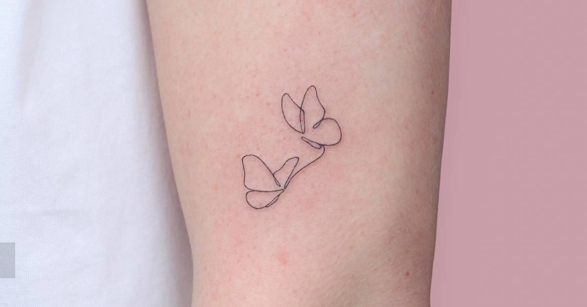 One line butterfly couple tattoo located on the upper
