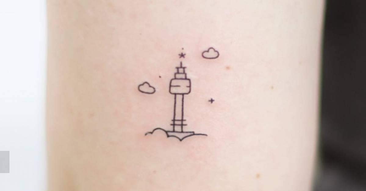 Seoul Tower tattoo placed on the tricep, minimalistic