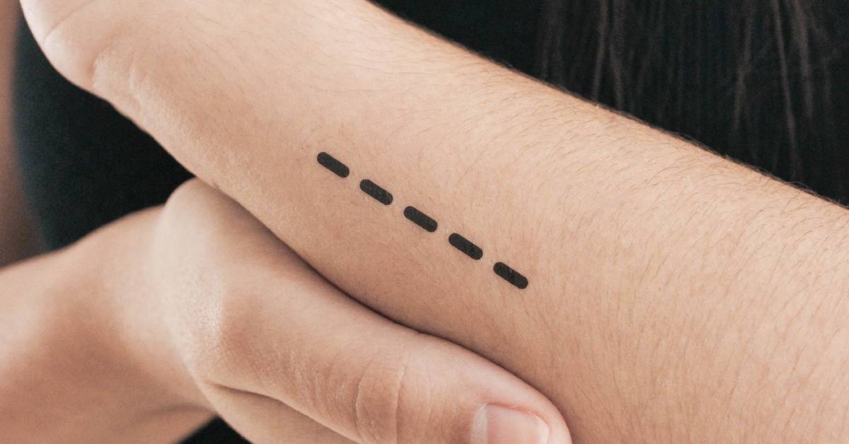 Morse Code 0 temporary tattoo located on the wrist.