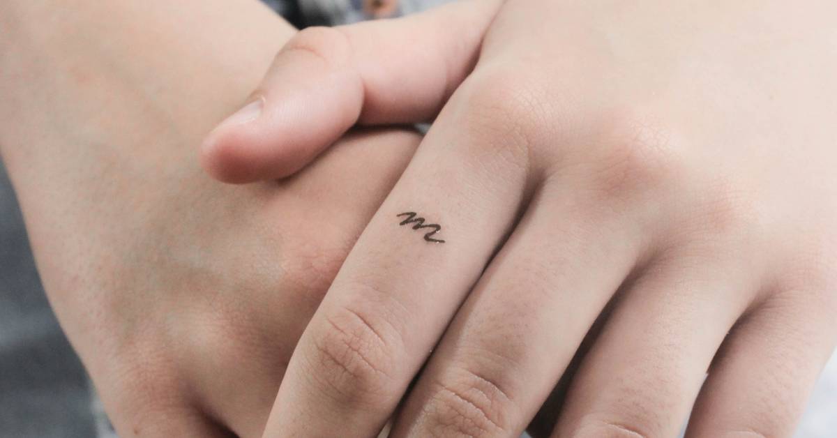 Little handwritten "m" letter temporary tattoo