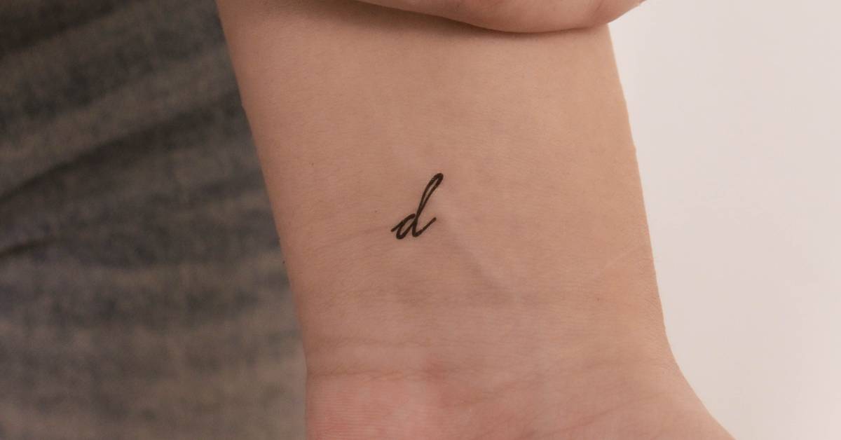 Little handwritten letter "d" temporary tattoo