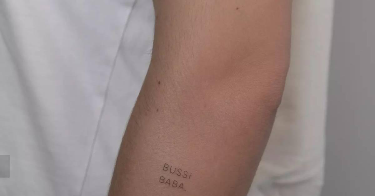 "Konfetti" and "bussi baba" lettering tattoos located