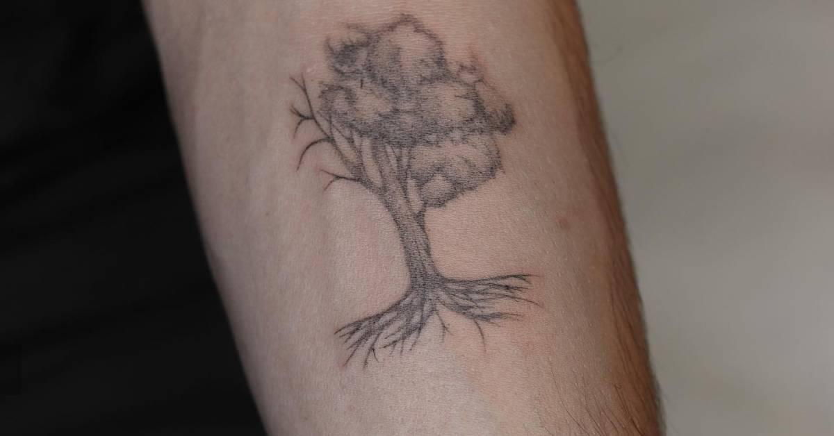 Illustrative style tree tattoo located on the inner