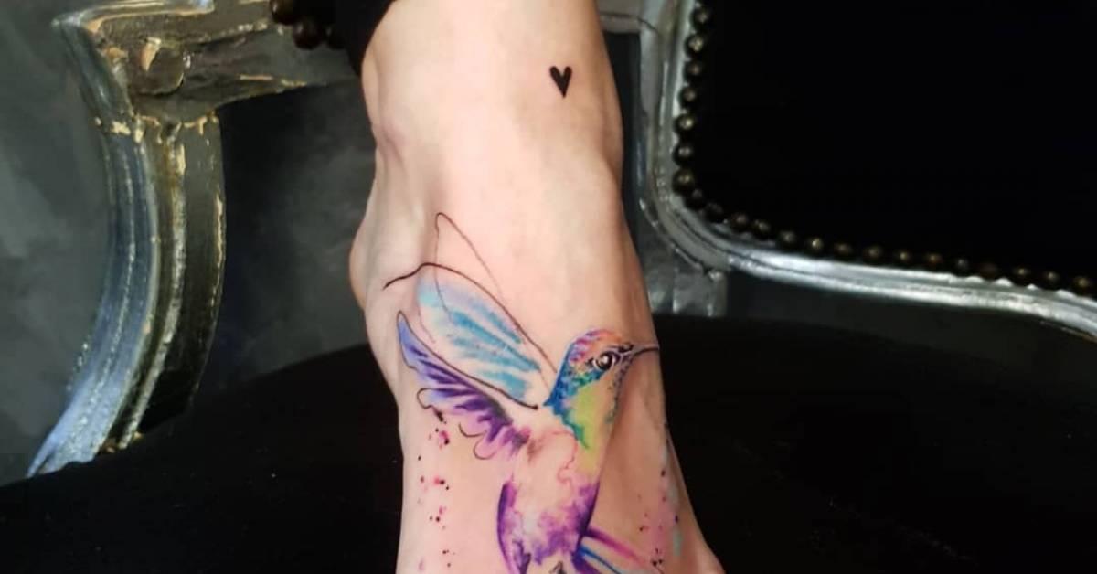 Colorful hummingbird tattoo located on the foot,