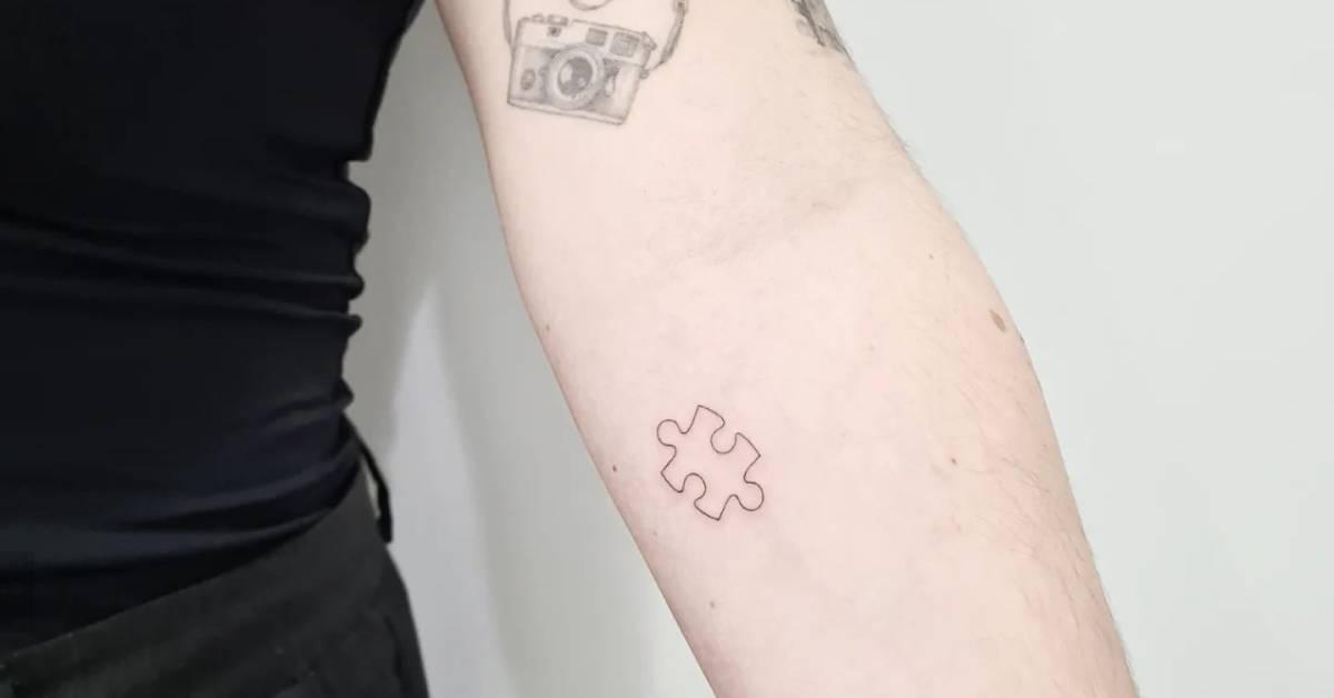 Fine line minimalistic puzzle piece tattoo done on the