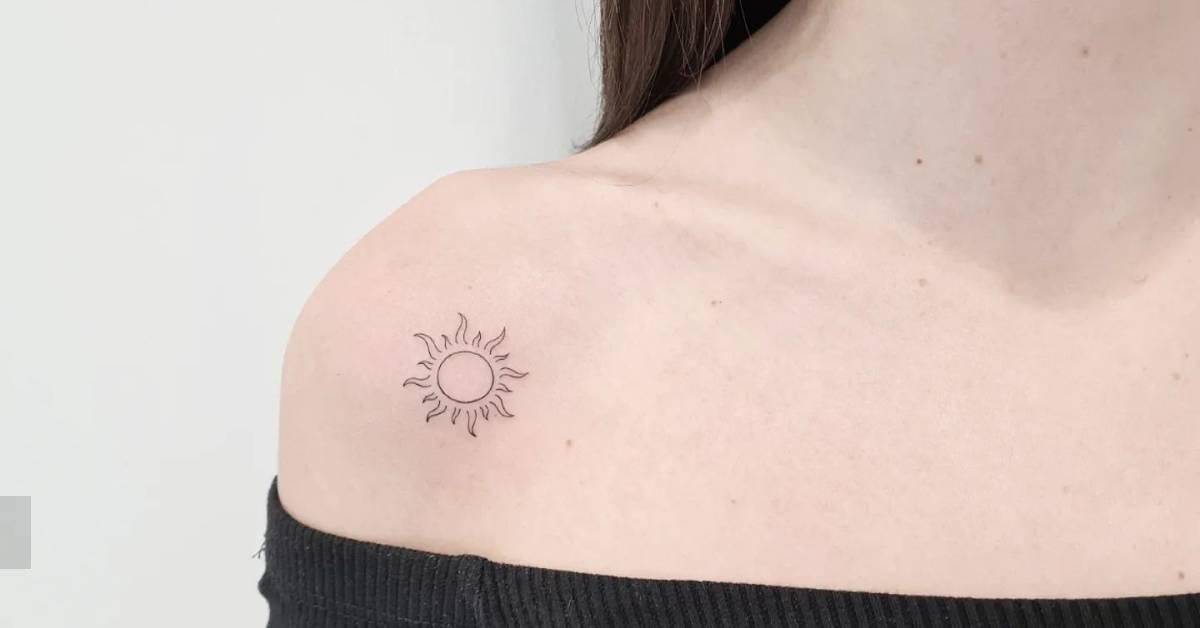 Fine line style sun tattoo located on the shoulder.