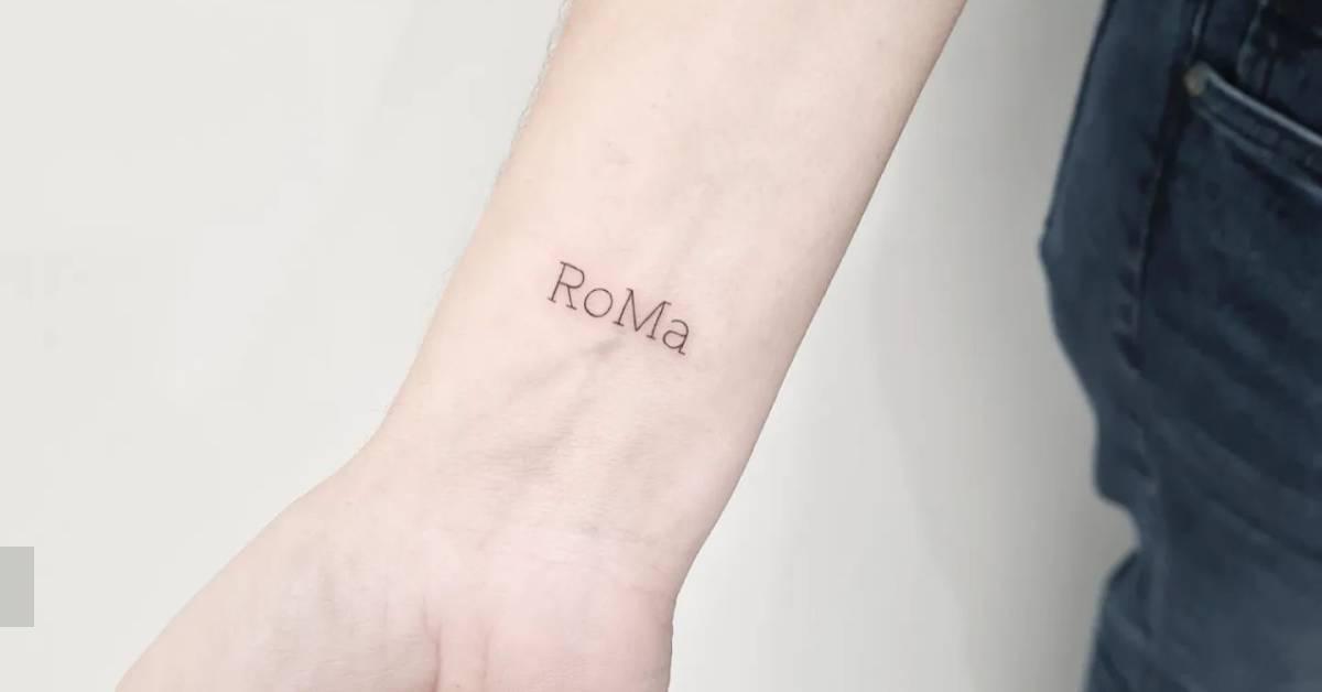 "Roma" lettering tattoo located on the wrist.