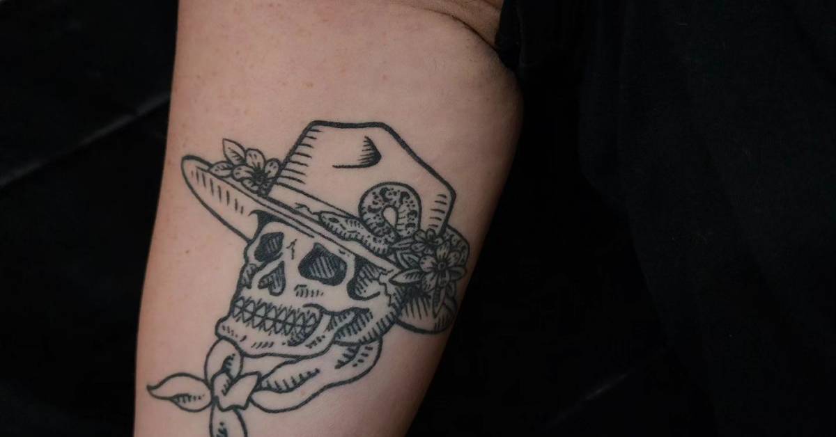 Healed engraving style cowboy skull tattoo located on