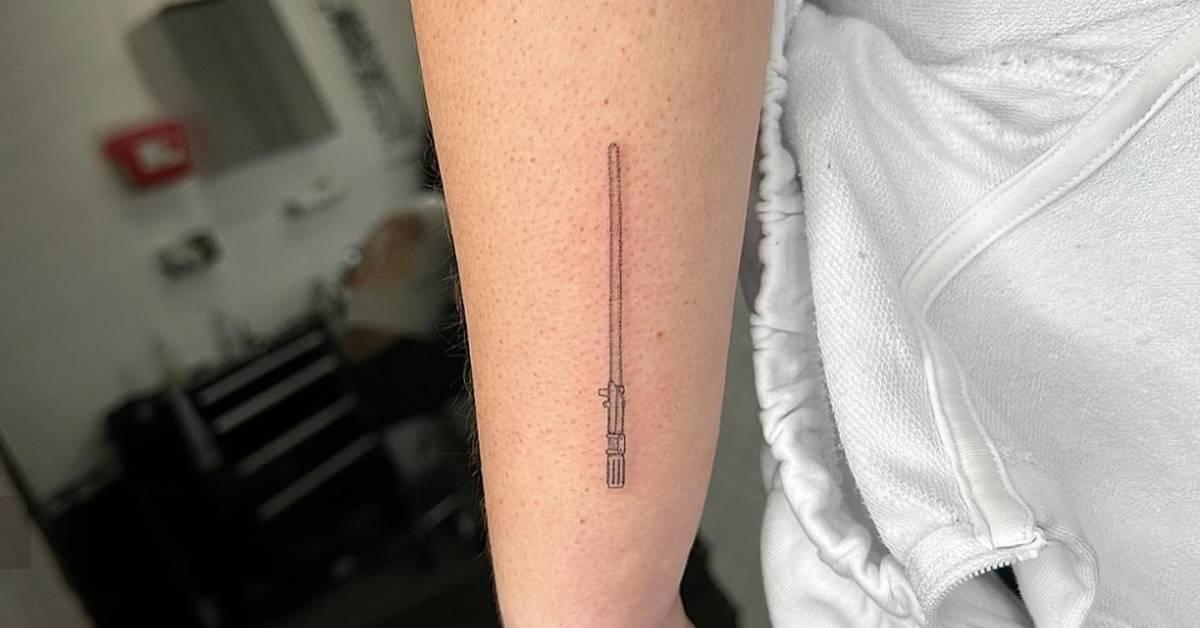 Single needle lightsaber tattoo placed on the wrist.