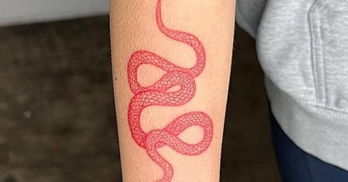 Fine line style red snake tattoo located on the