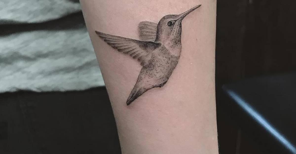 Micro-realistic style hummingbird tattoo located on the