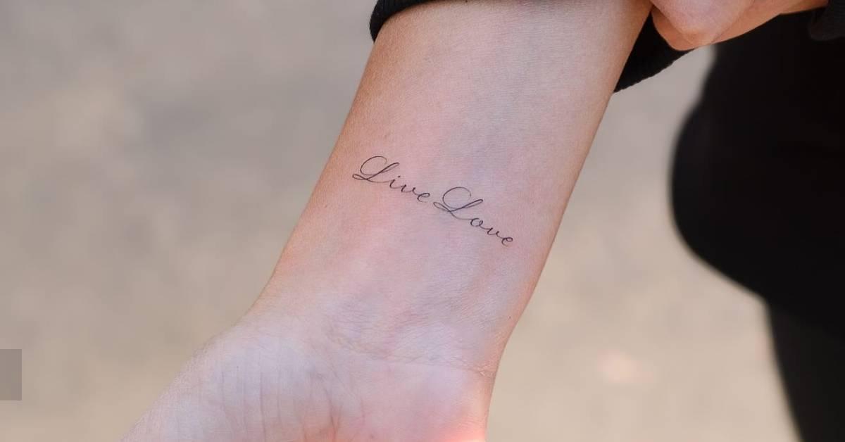 "Live love" lettering tattoo handwritten on the wrist.
