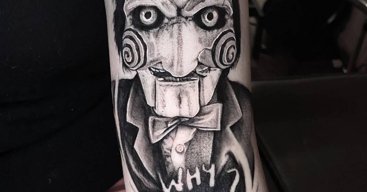 Billy the Puppet tattoo located on the bicep.