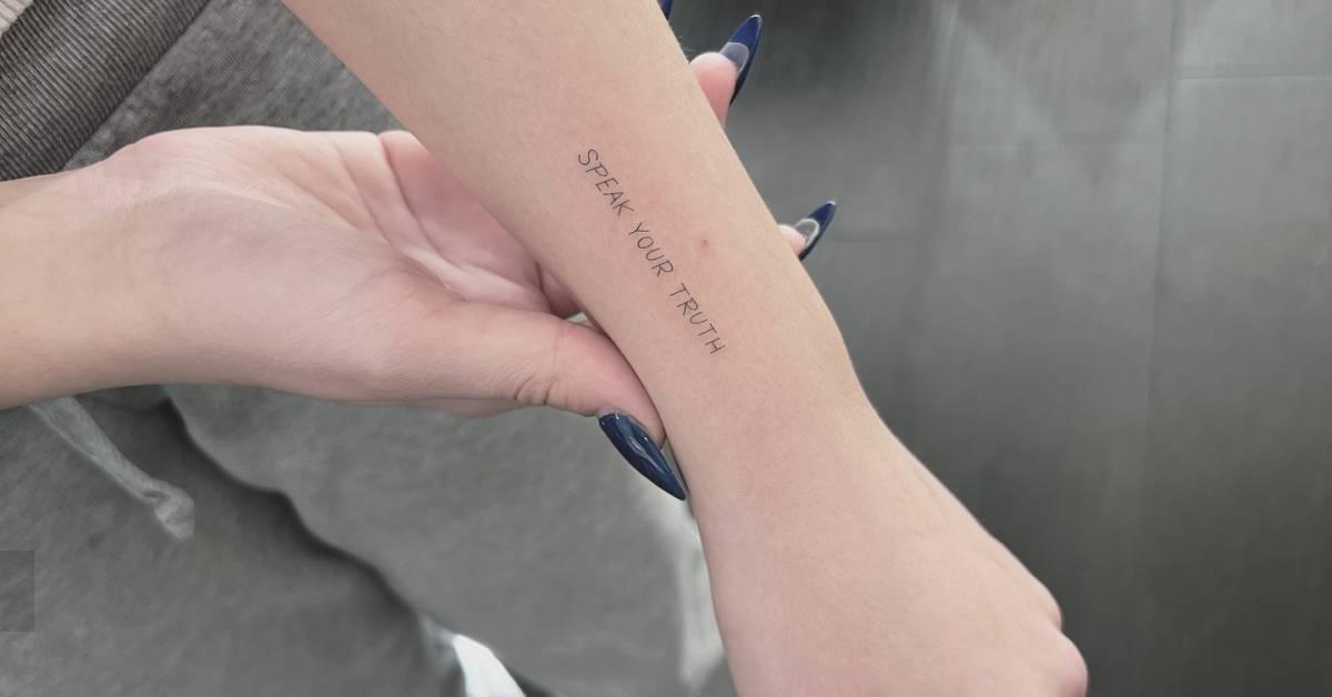 Lettering tattoo that says "speak your truth" located
