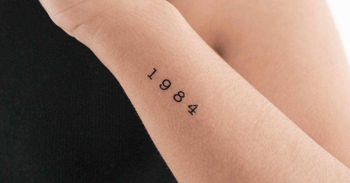 "1984" birth year temporary tattoo located on the
