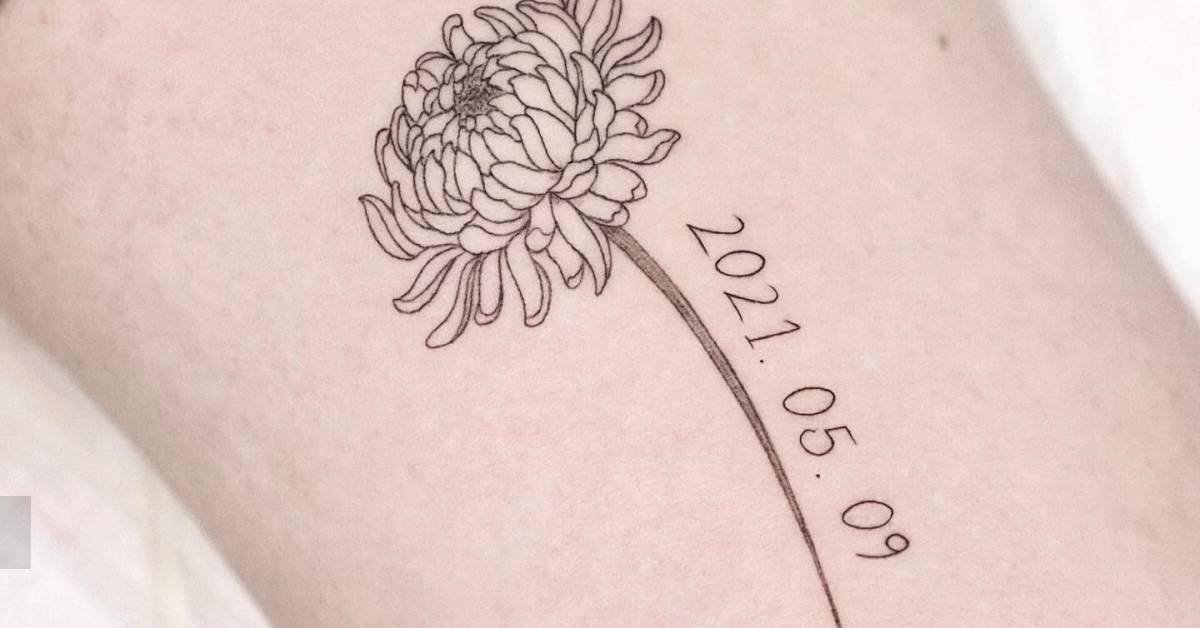 Chrysanthemum and date tattoo located on the inner arm,