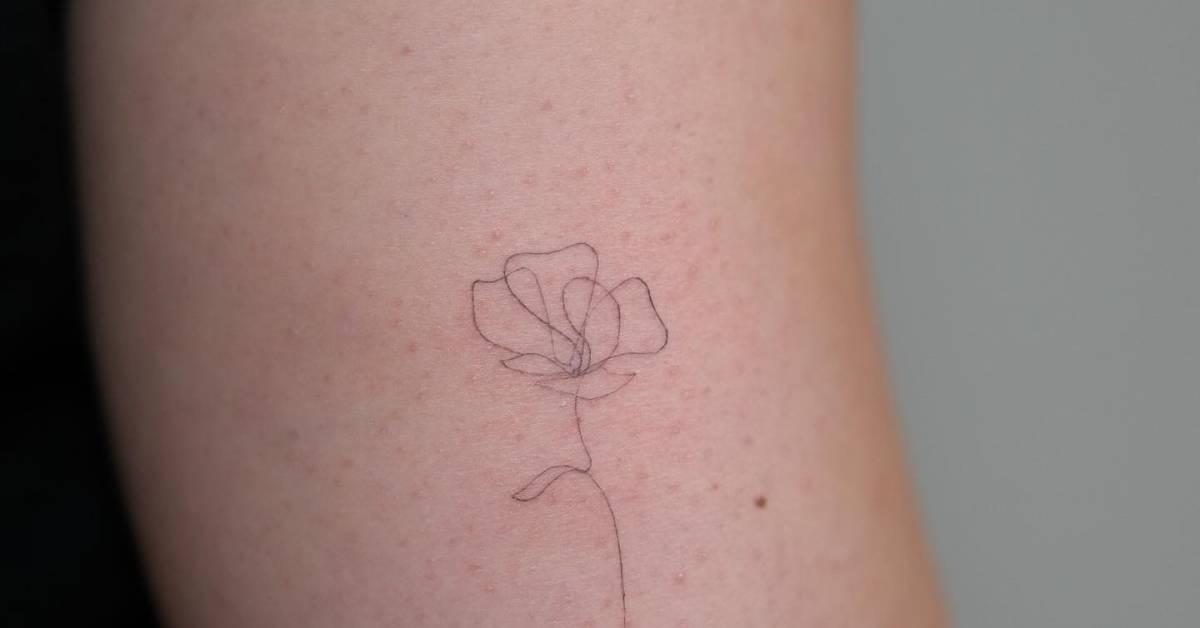 Poppy flower tattoo done on the tricep, fine line
