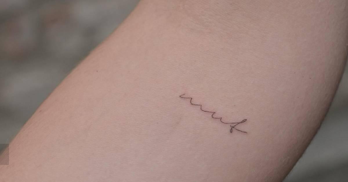"Mut" lettering tattoo located on the inner forearm.