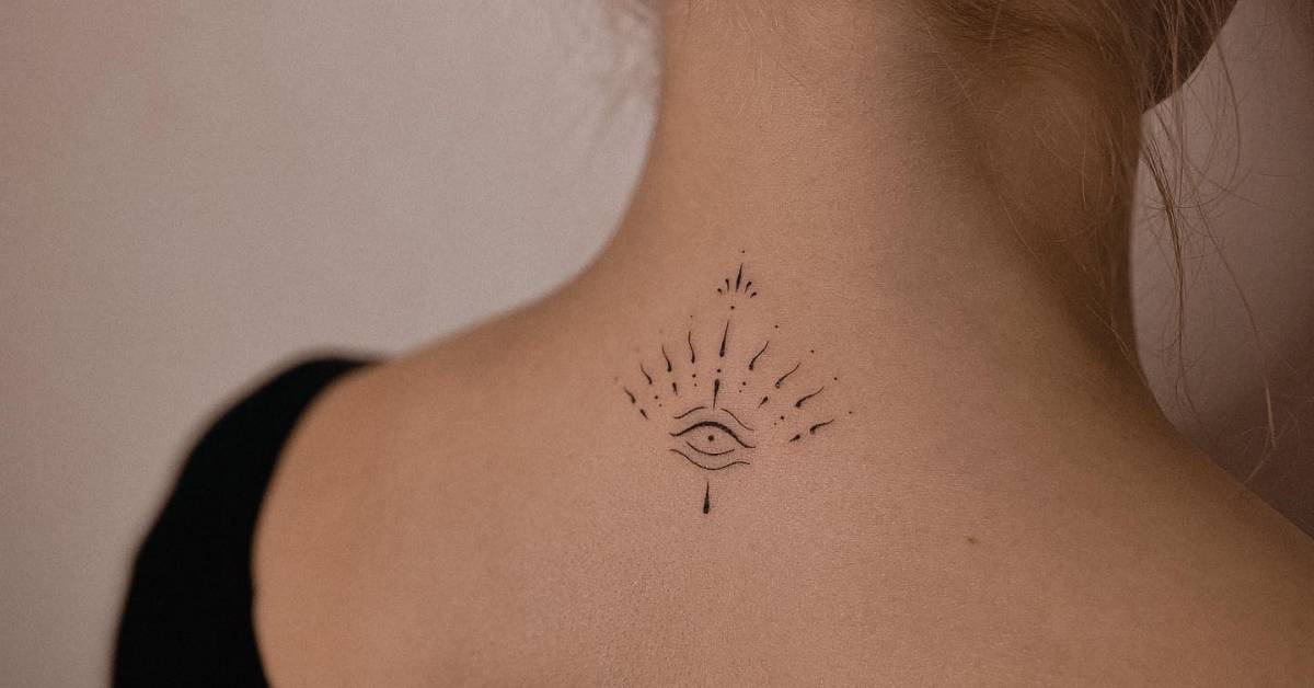 Fine line style eye ornament tattoo located on the