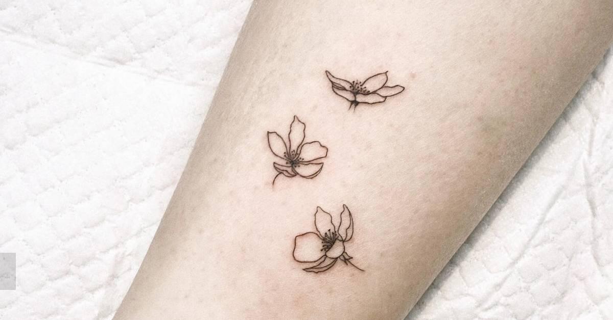 Fine line style flowers tattoo located on the ankle.