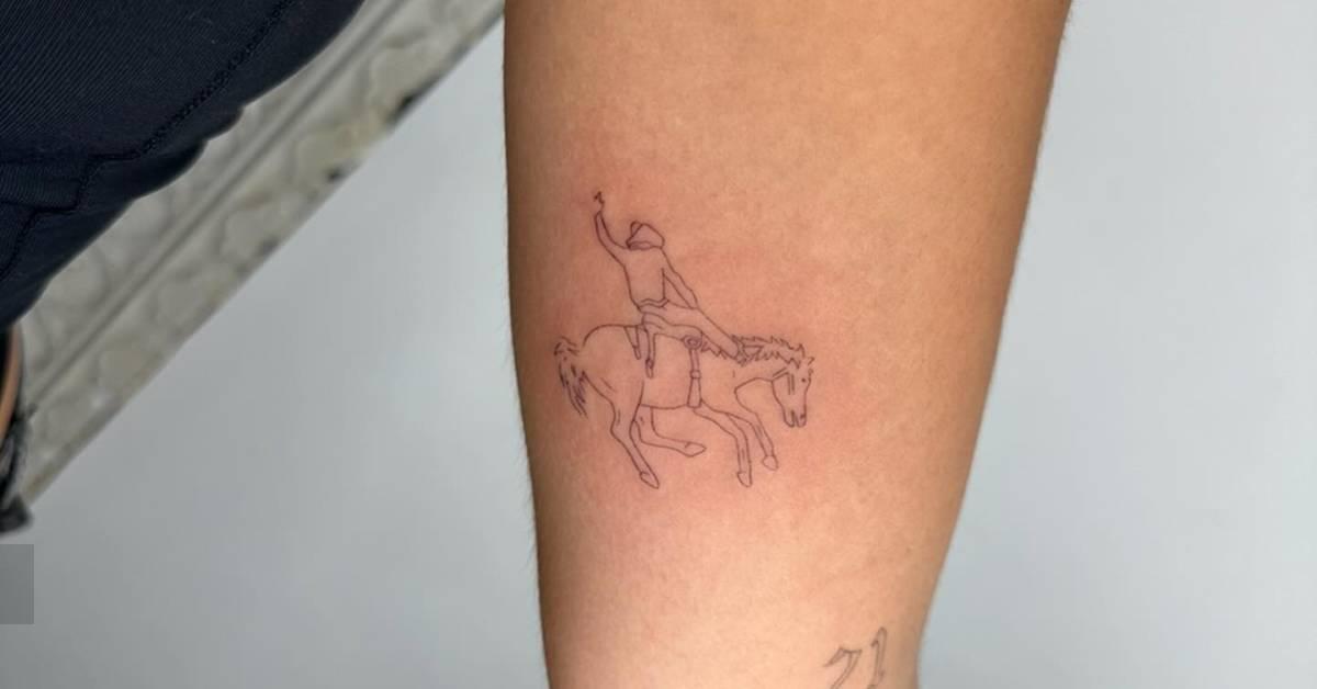 Fine line style cowboy and horse tattoo located on the