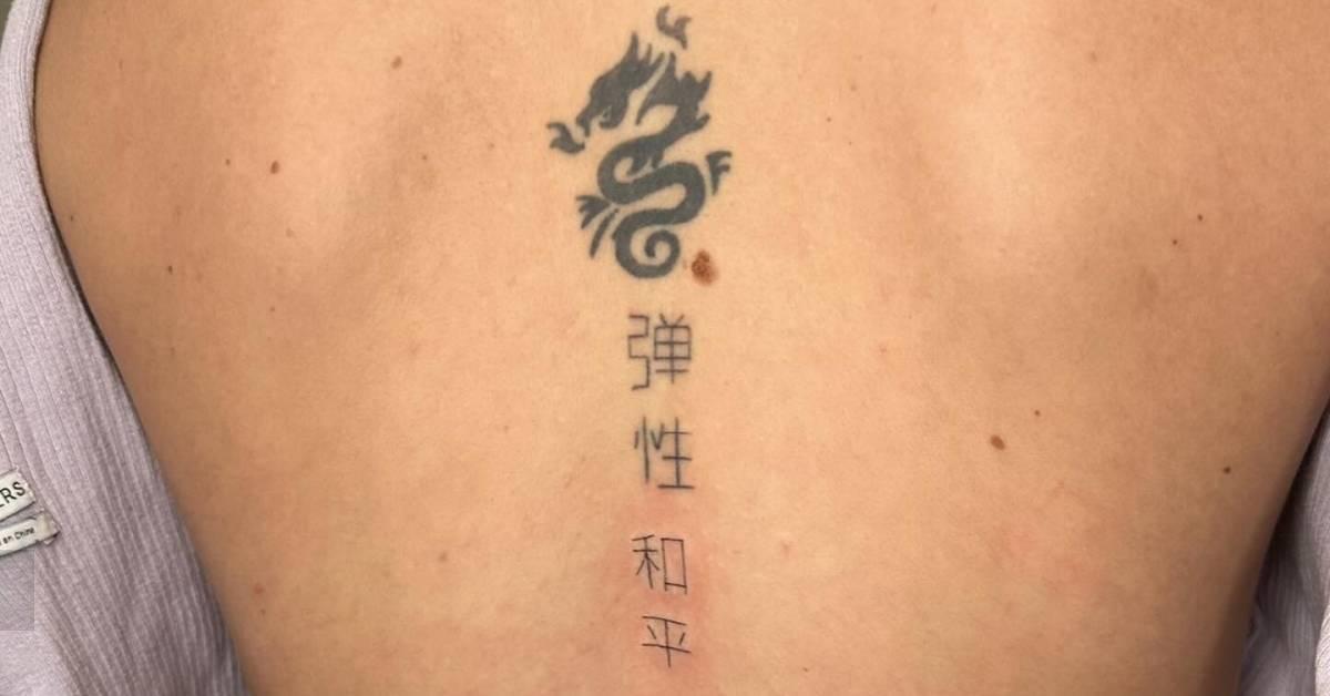 Chinese characters tattooed on the spine.