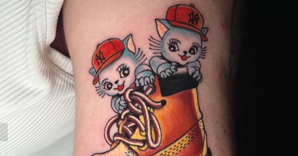 Bodega Cats and Timberland boots tattooed on the bicep.