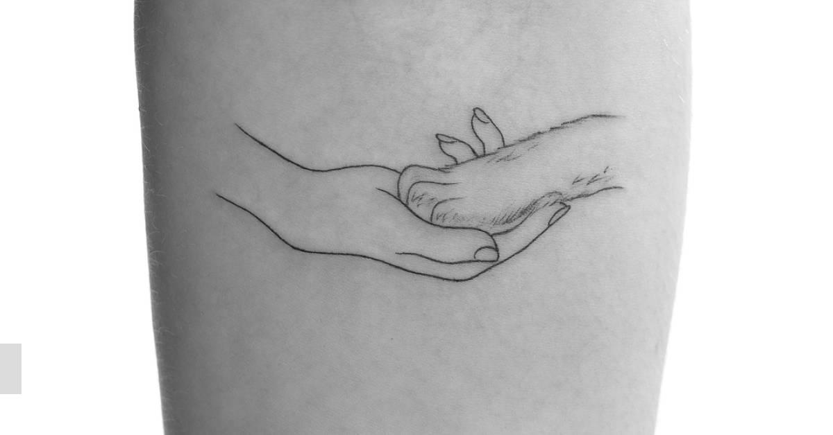 Hand and paw tattoo located on the inner forearm, fine