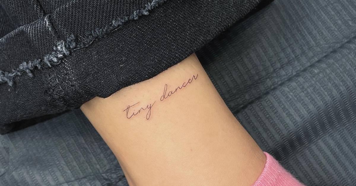 "Tiny dancer" lettering tattoo located on the ankle.