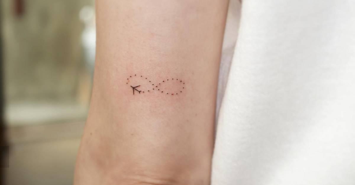 Airplane and infinity symbol tattoo placed on the