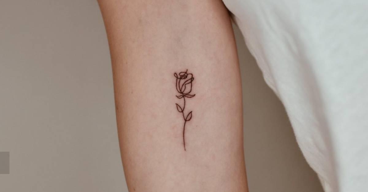 One line rose tattoo located on the inner arm.