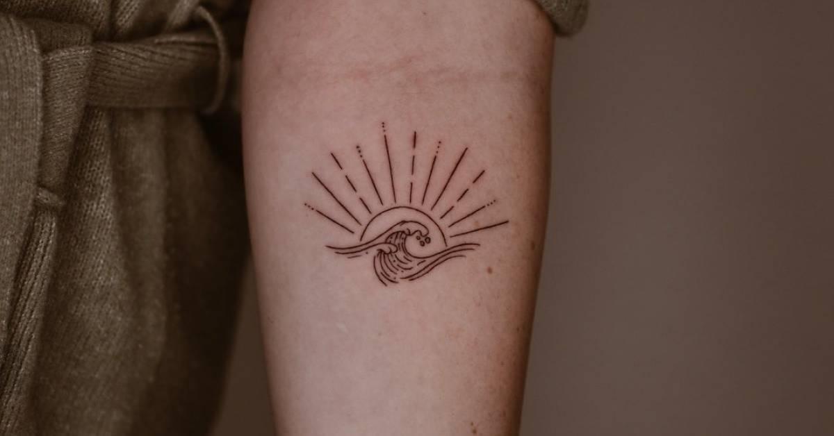 Fine line sun and moon tattoo located on the inner