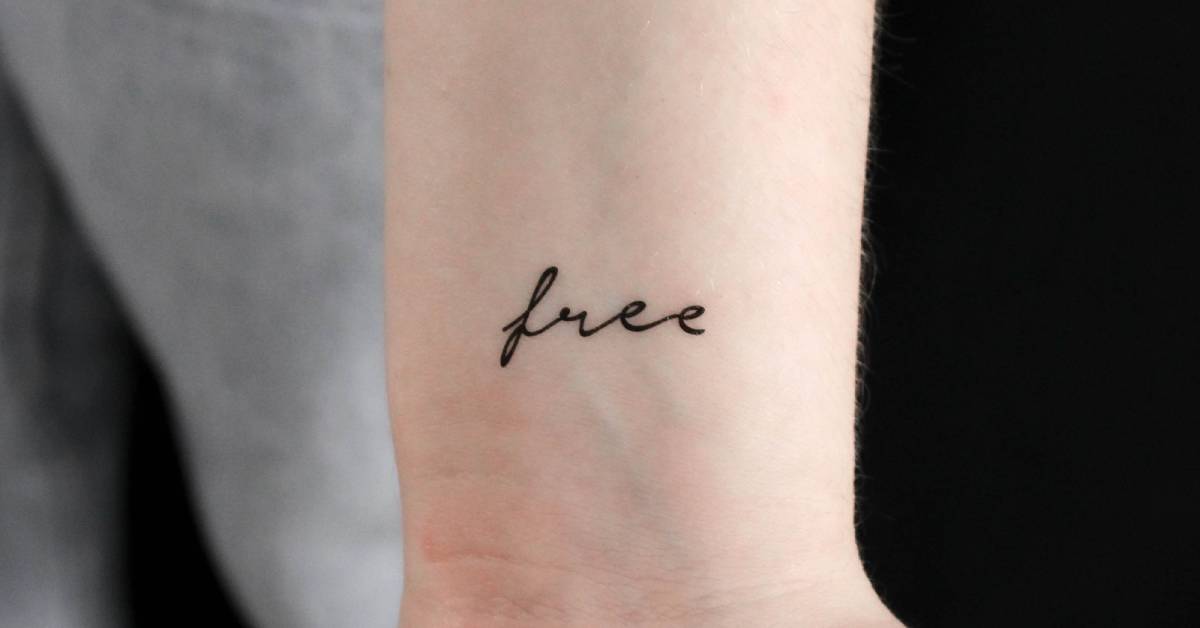 Temporary lettering tattoo of the word "free" located